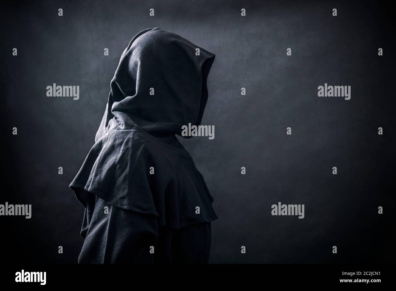 Scary figure in hooded cloak Stock Photo - Alamy