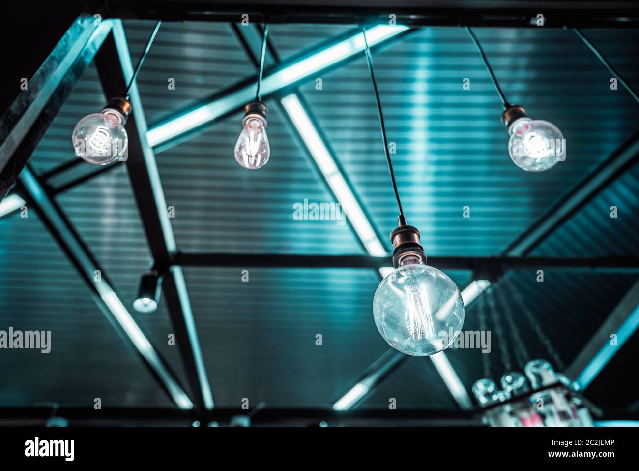 Group of teal and blue hanging lamps of different shapes and type of ...