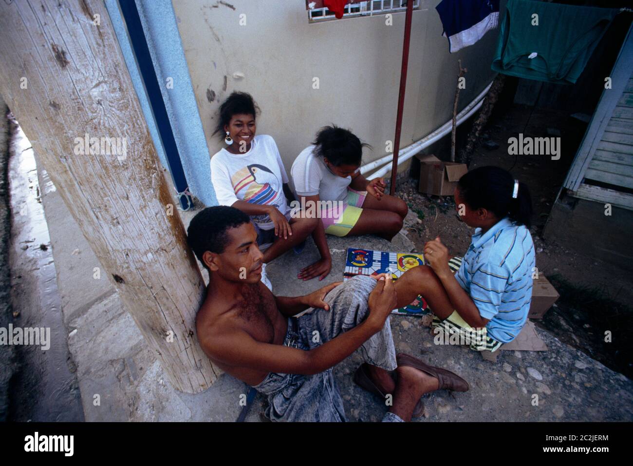 Dominican Republic Los Charamicos Family Sitting In Street Stock Photo ...