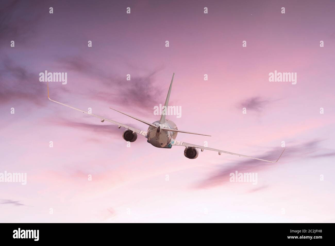 Airplane aft plane in the sky at sunset sky Stock Photo - Alamy