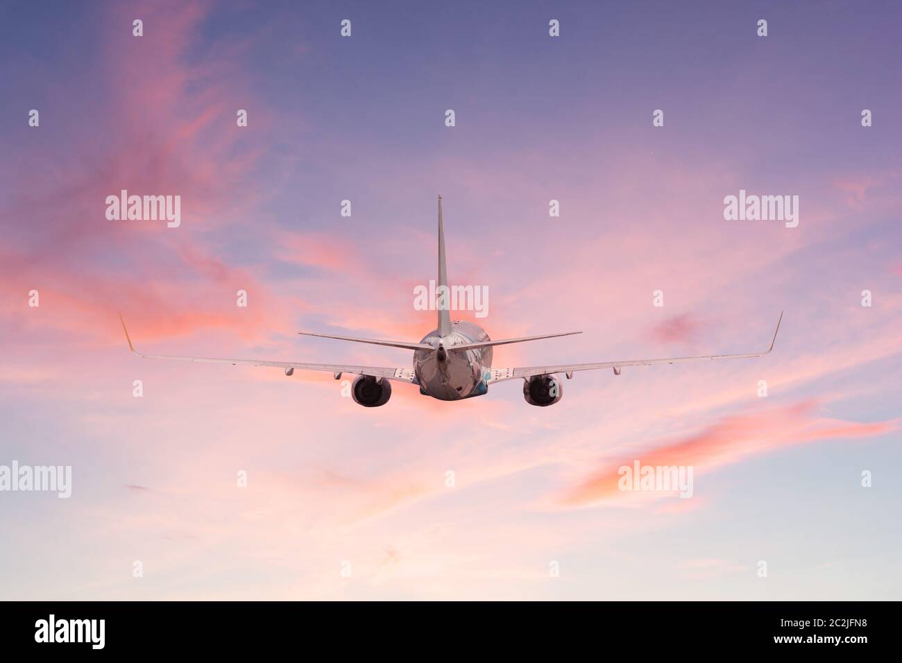 Airplane aft plane in the sky at sunset sky Stock Photo - Alamy