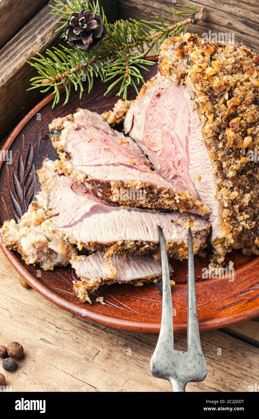 Baked meat under a bread crust with nuts Stock Photo - Alamy