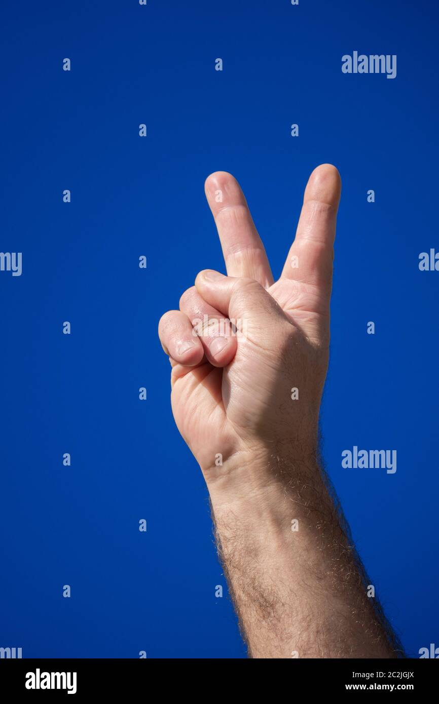 male hand V sign Stock Photo - Alamy