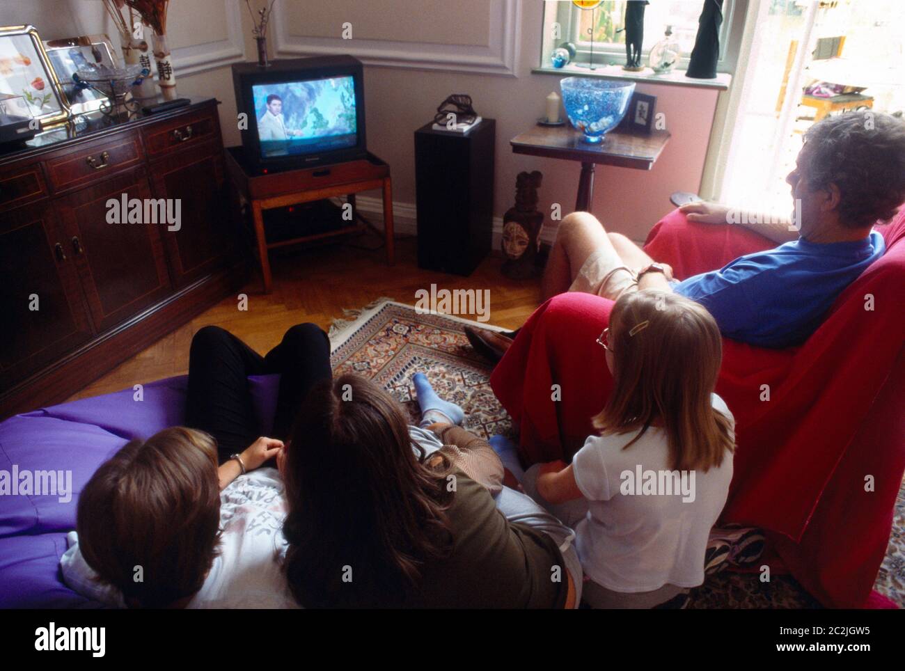 Family watching Weather Forecast on the Television Surrey England Stock ...