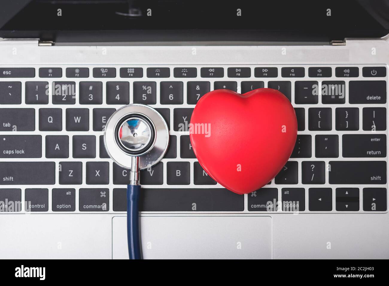 Health stethoscope and red heart on keyboard of laptop computer ...