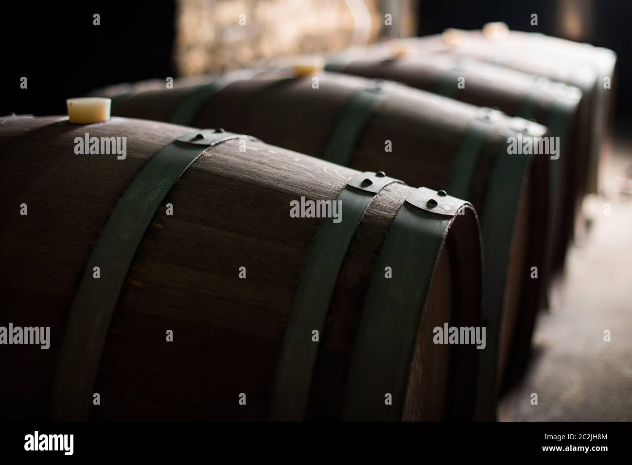 Close up shot of some wooden barrels in a dark wine cellar Stock Photo ...
