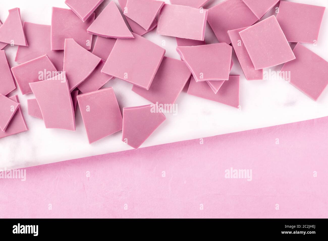 Ruby chocolate, shot from the top on a pink background with a place for ...