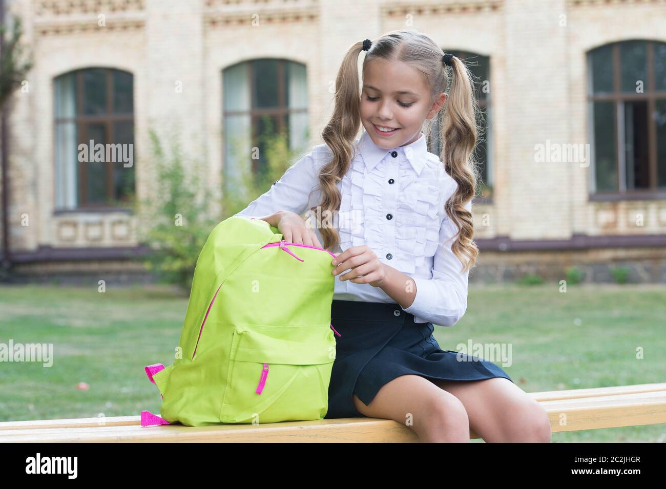 Doing homework outdoors. Small child do homework. Little girl open ...