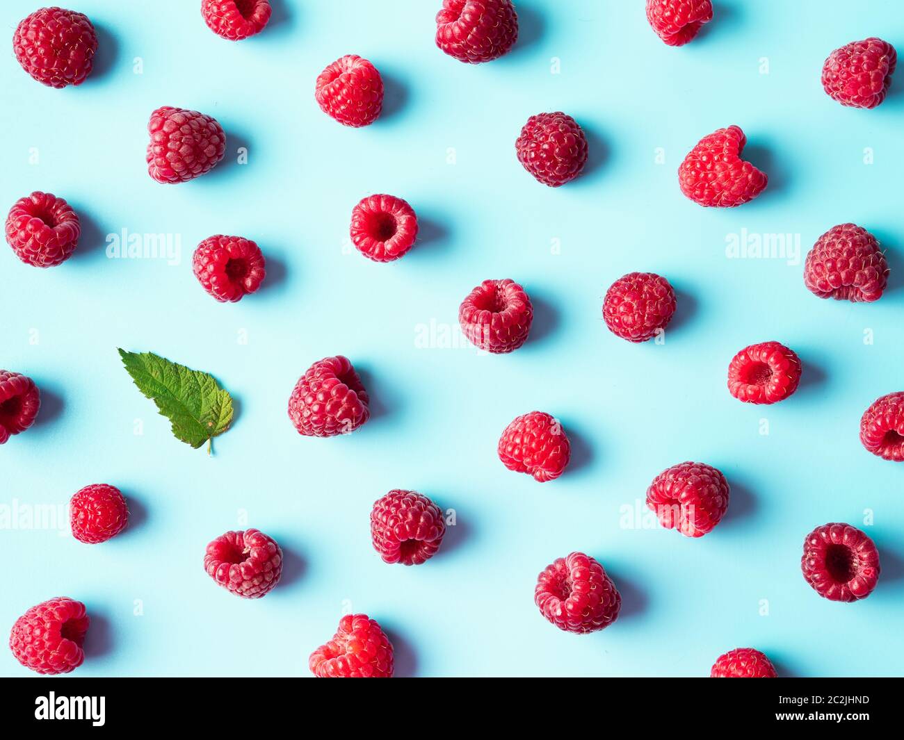 Raspberry pattern, blue background, top view Stock Photo - Alamy