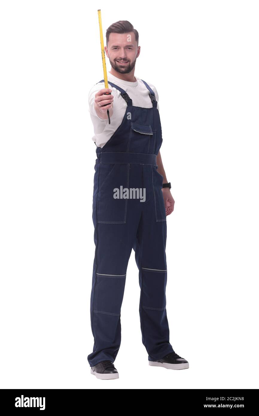 man in overalls with a construction tape measure. isolated on white ...