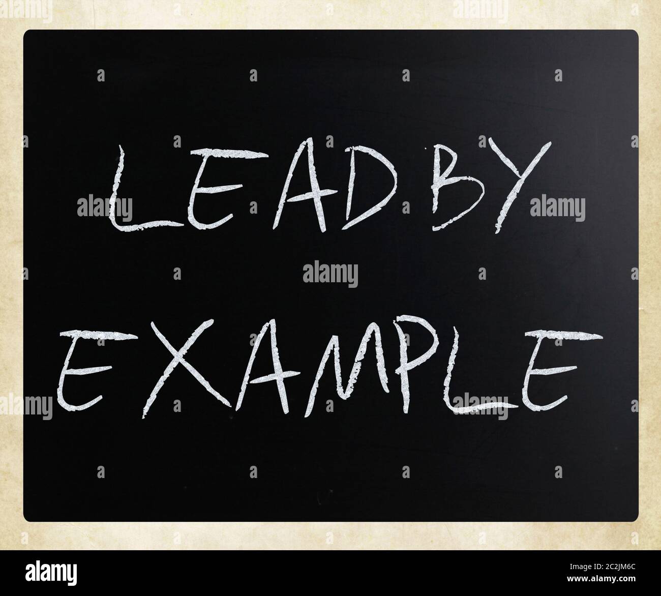 "Lead by example" handwritten with white chalk on a blackboard Stock ...
