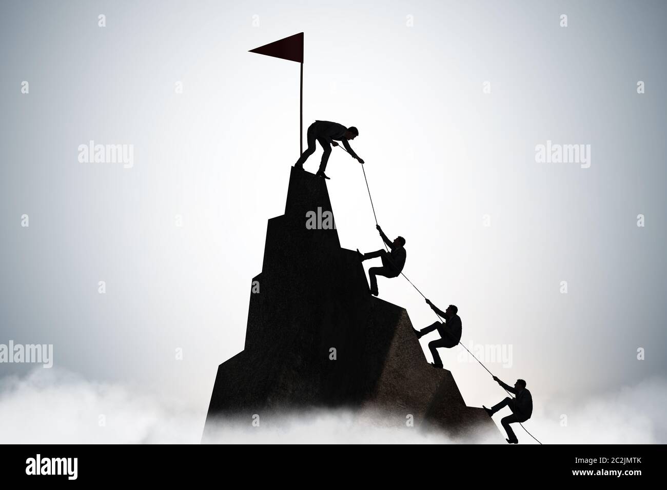 Concept of teamwork with team climbing mountain Stock Photo - Alamy