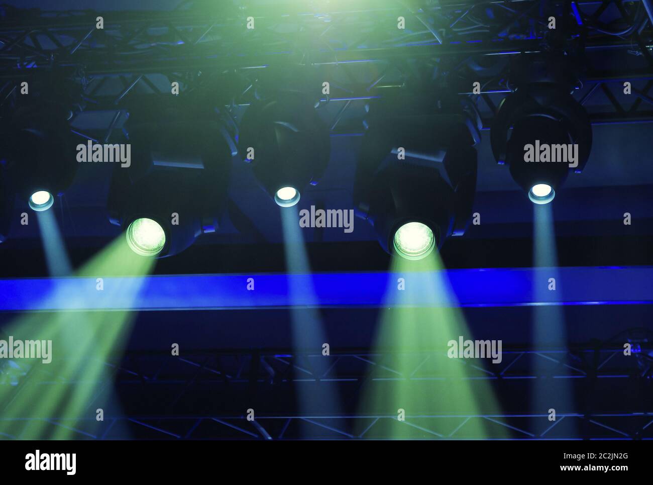 stage spotlights projecting lights during a live event Stock Photo - Alamy