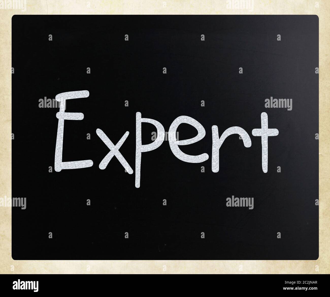 The word "Expert" handwritten with white chalk on a blackboard Stock ...