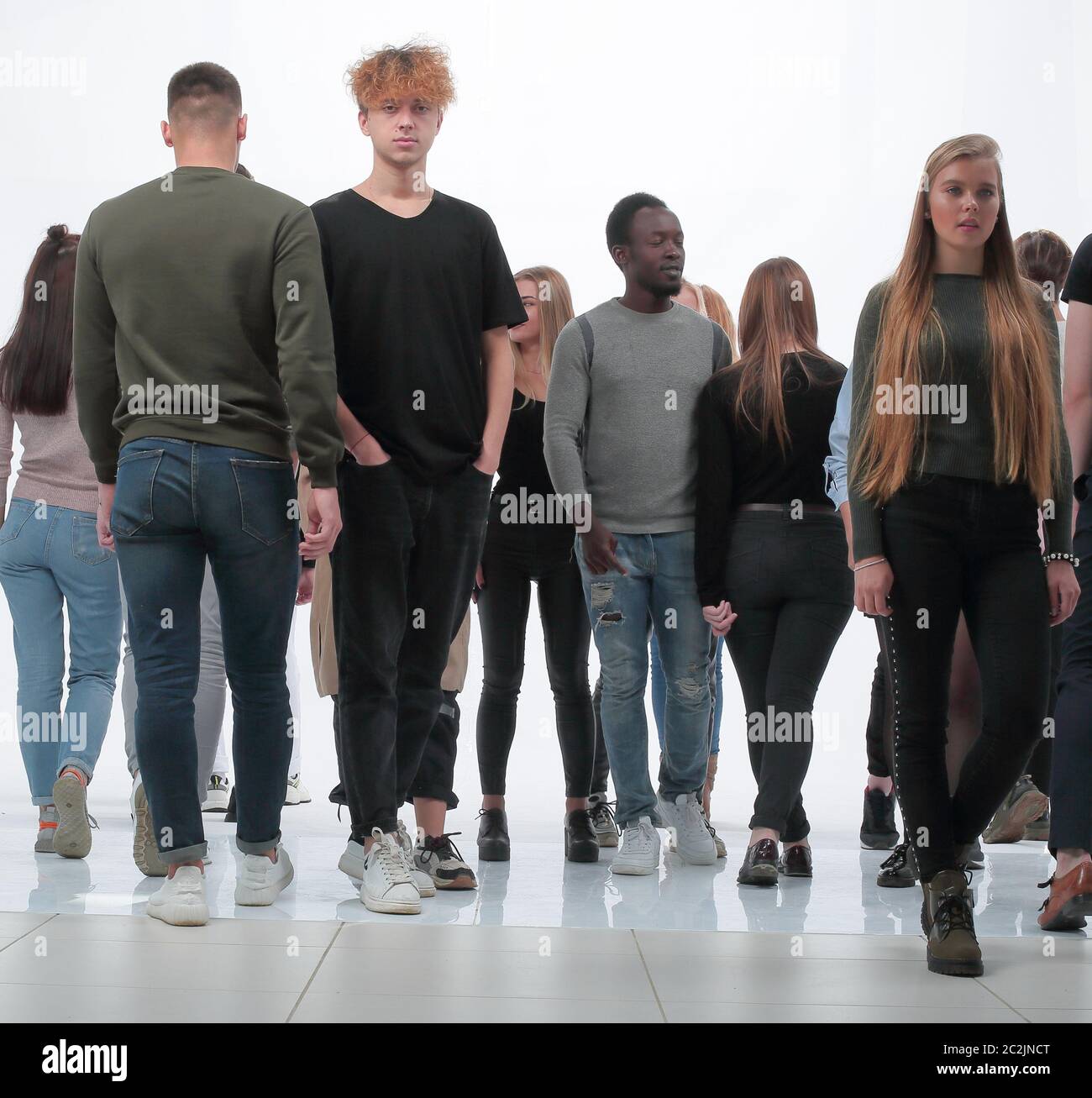 groups of diverse young men striding towards each other Stock Photo - Alamy