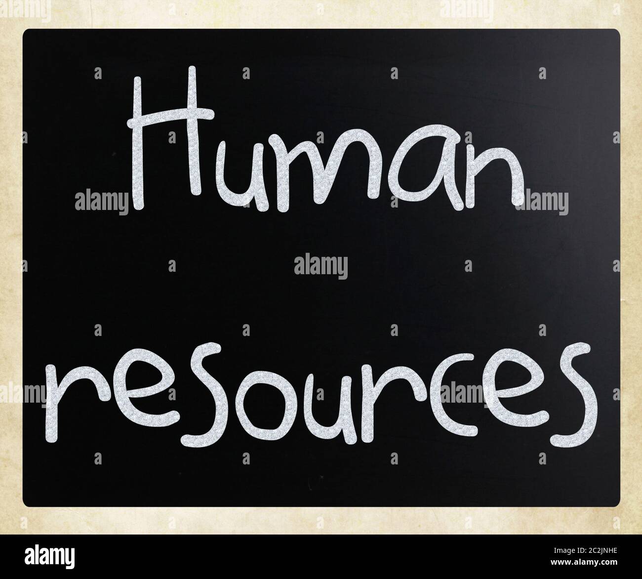 The word 'Human resources' handwritten with white chalk on a blackboard ...