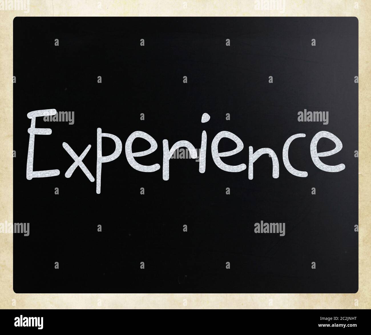 The word "Experience" handwritten with white chalk on a blackboard ...