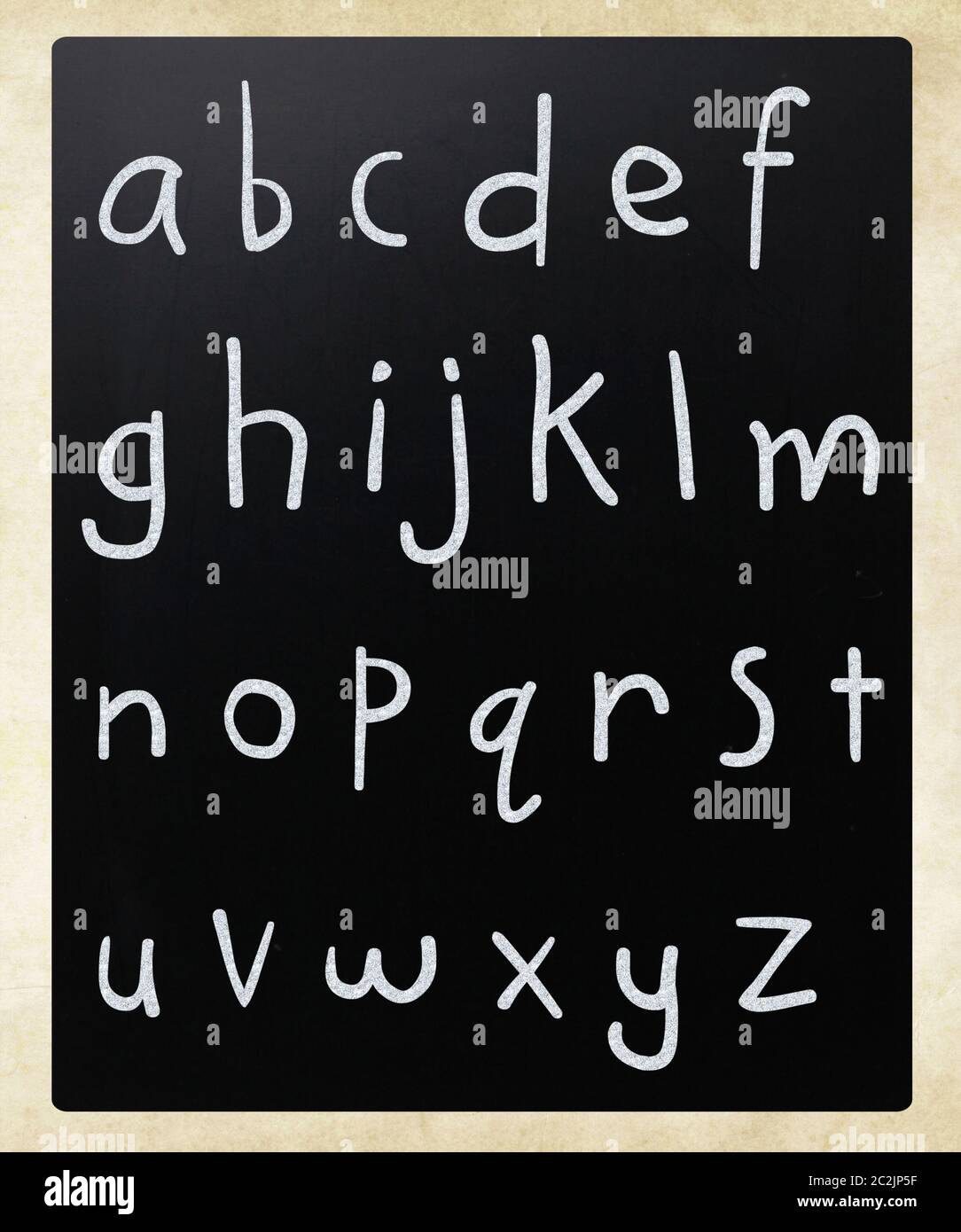 Complete english alphabet handwritten with white chalk on a blackboard ...
