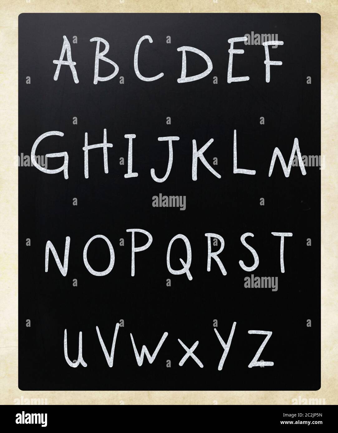 Complete english alphabet handwritten with white chalk on a blackboard ...