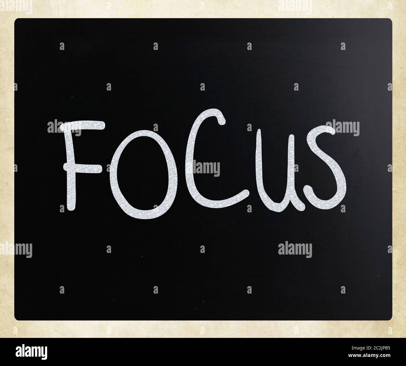 The word "Focus" handwritten with white chalk on a blackboard Stock ...