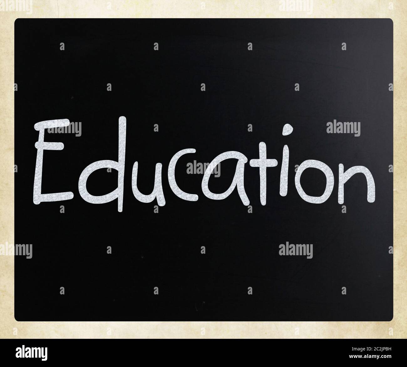 The word "Education" handwritten with white chalk on a blackboard Stock ...