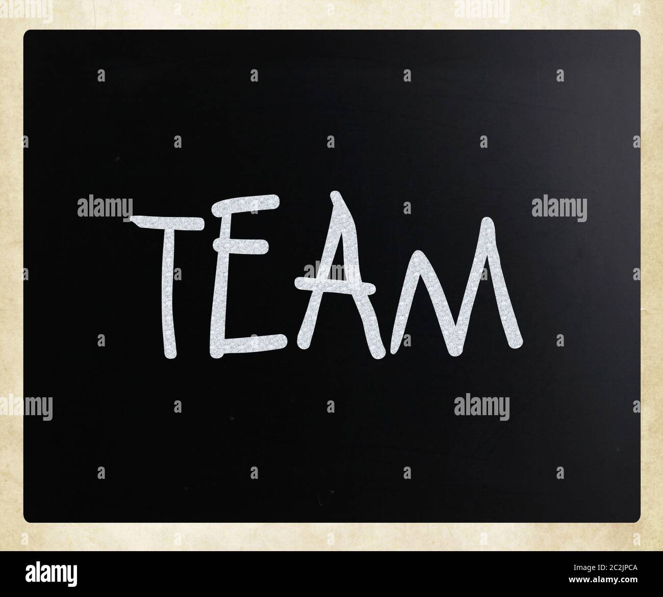 The word "TEAM" handwritten with white chalk on a blackboard Stock ...
