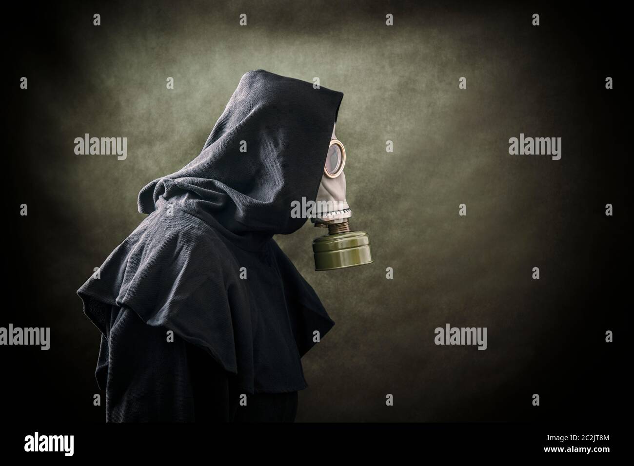 Man in a gas mask and hooded cloak. Environment pollution Stock Photo ...