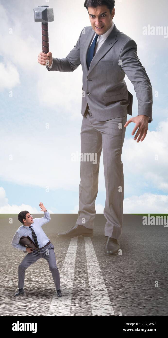 Bad angry boss threatening employee with hammer Stock Photo - Alamy