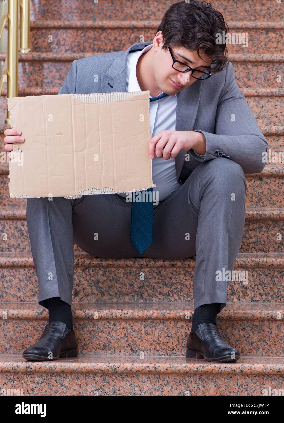 Desperate businessman begging on the street Stock Photo - Alamy