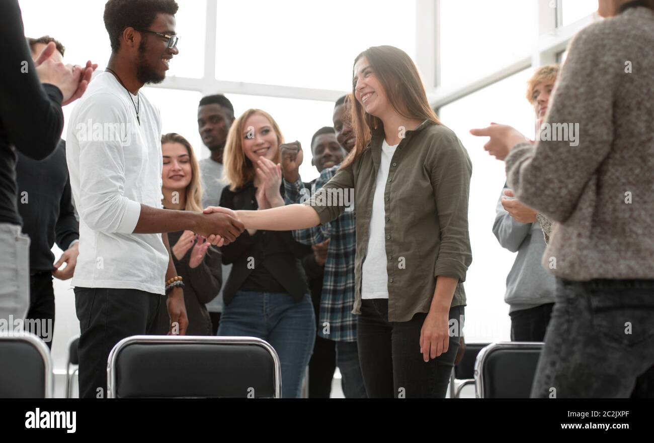 group of happy young people congratulating their colleague Stock Photo ...
