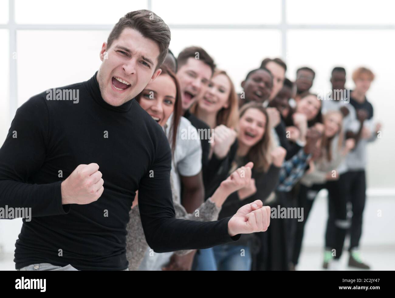 group of happy young people standing behind each other Stock Photo - Alamy