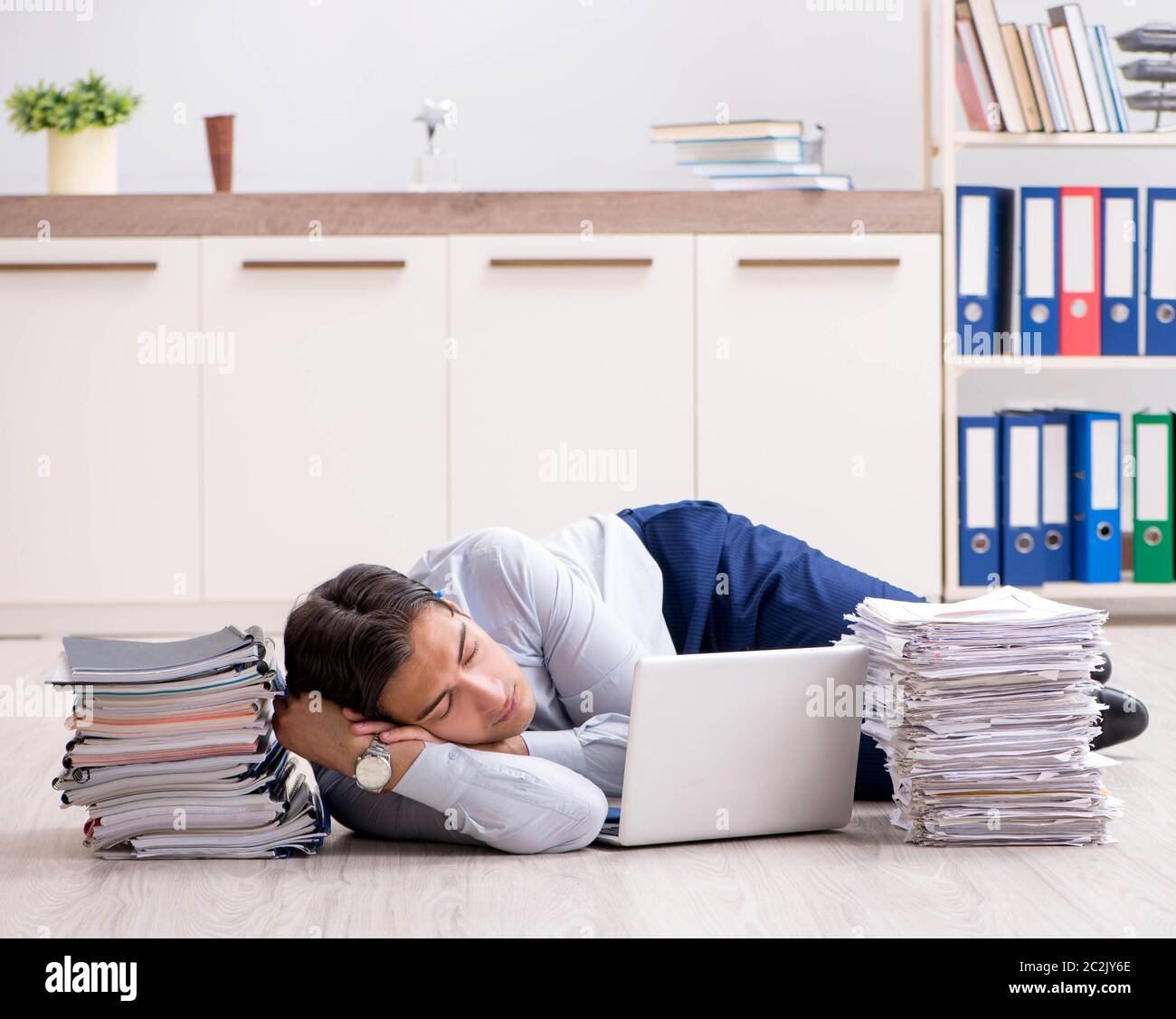 The extremely busy employee working in the office Stock Photo - Alamy