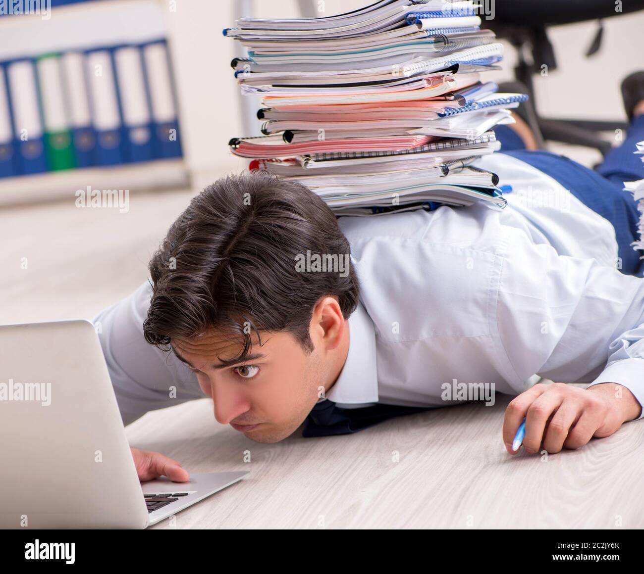 The extremely busy employee working in the office Stock Photo - Alamy