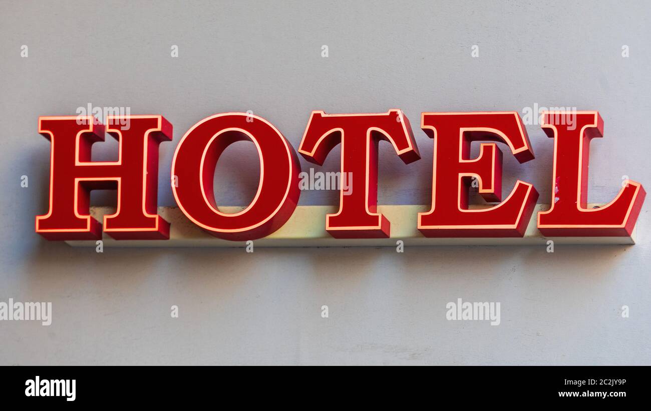 Red Neon Hotel Sign at White Wall Stock Photo - Alamy