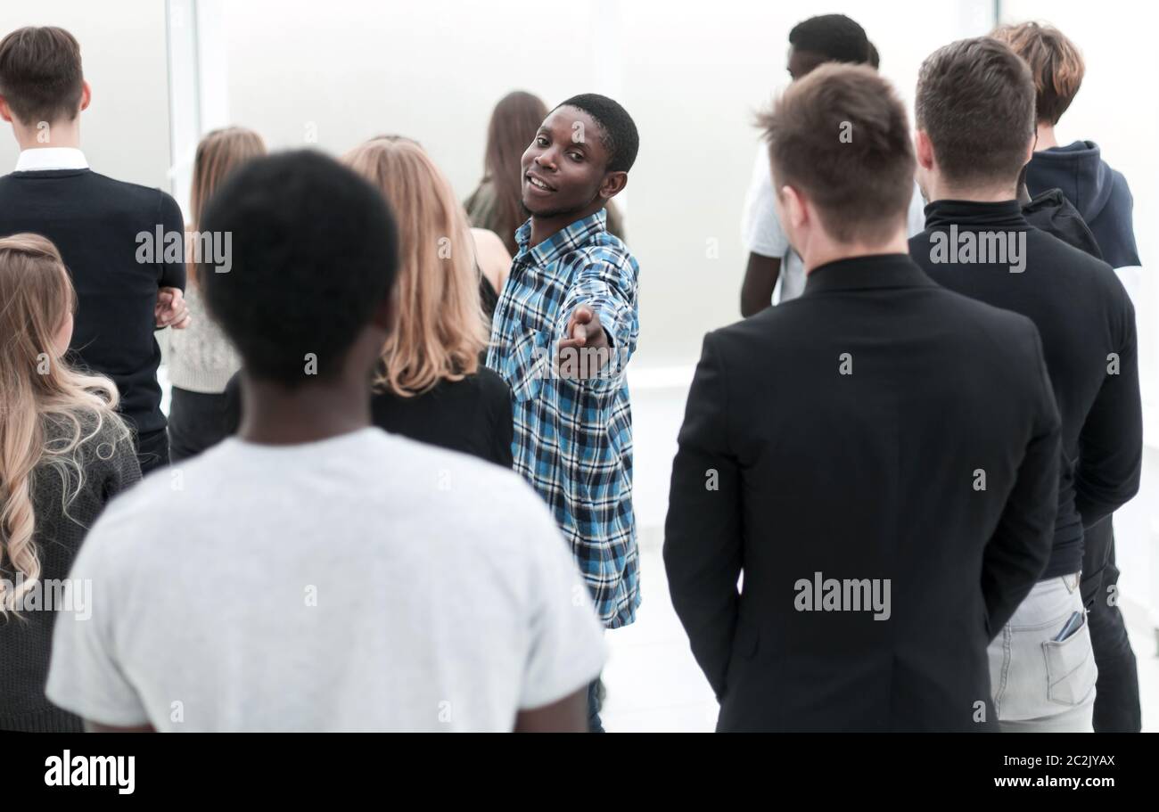 young man standing among a group of diverse young people Stock Photo ...