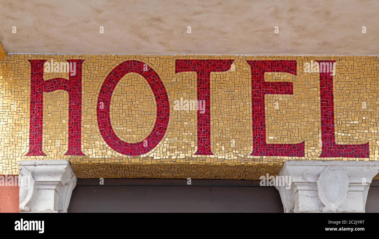 Old Style Hotel Letters Sign at Golden Tiles Mosaic Stock Photo - Alamy