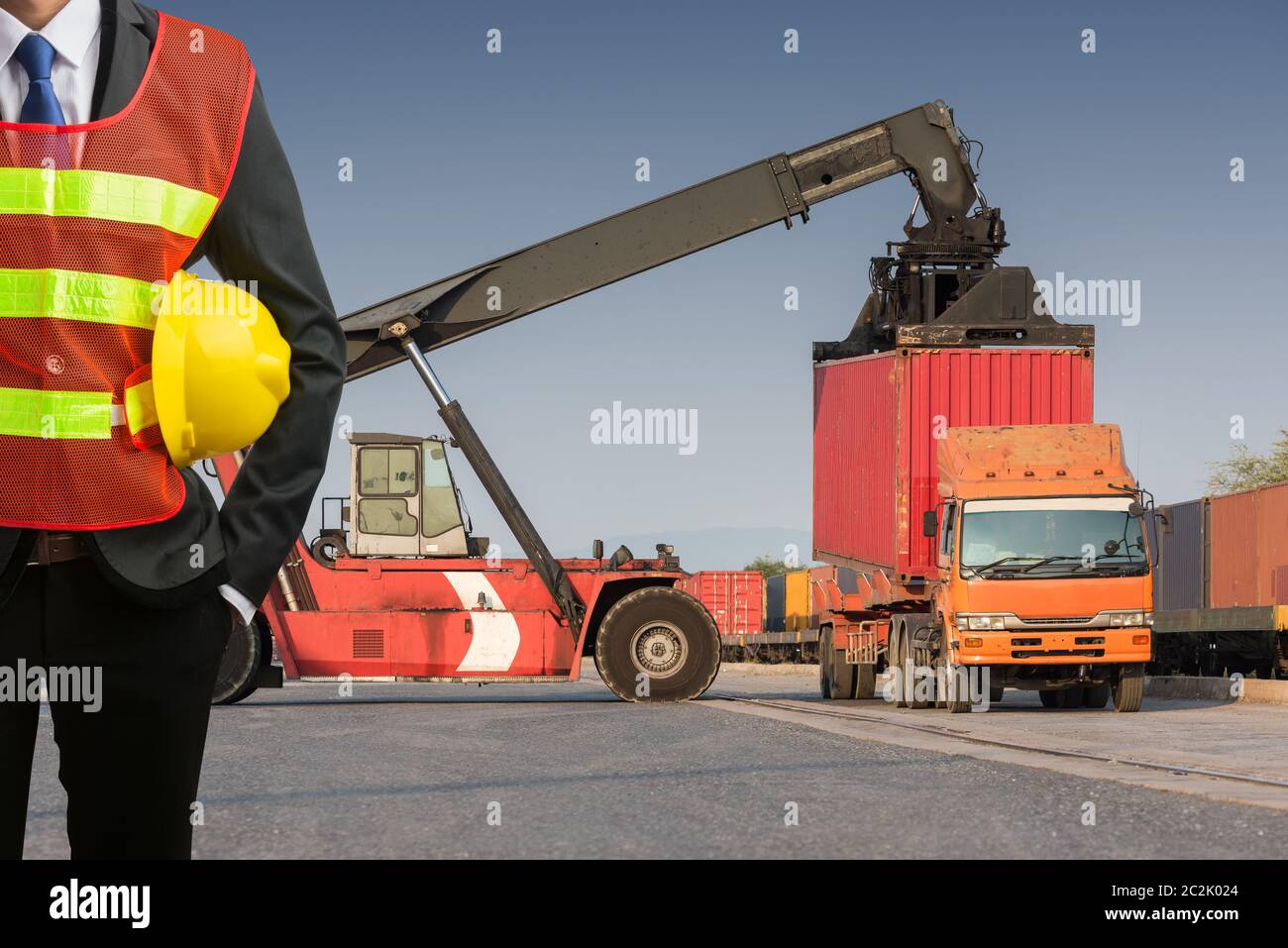 Businessman stand on front forklift loading Containers box to Logistic ...