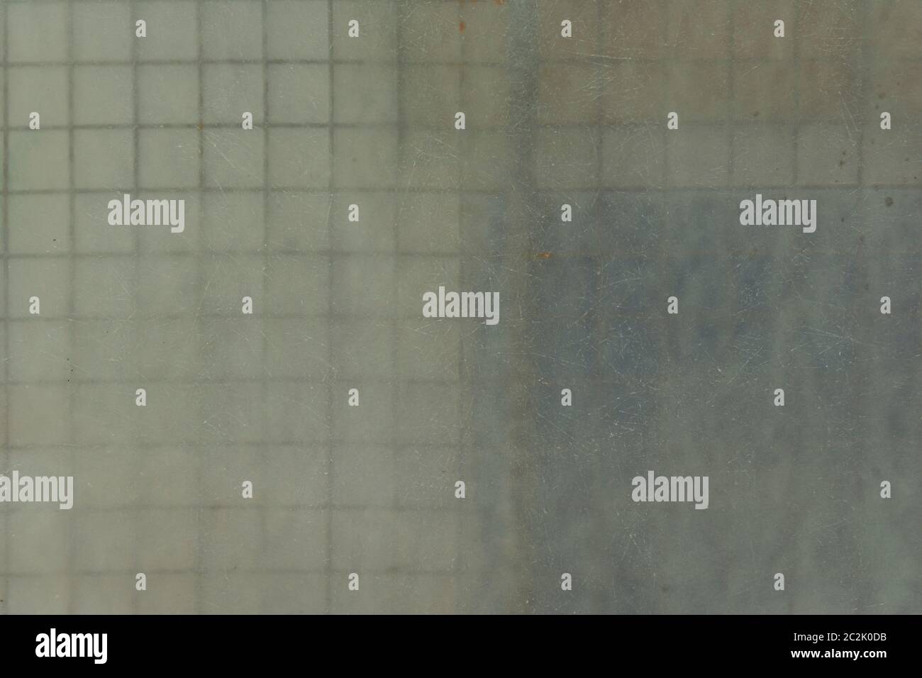 Matt transparent plate in front of metal bars squares, abstract ...