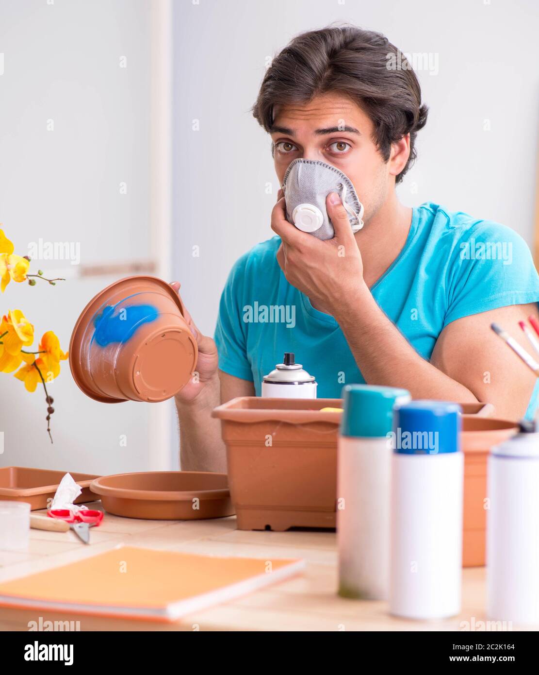 The young man decorating pottery in class Stock Photo - Alamy