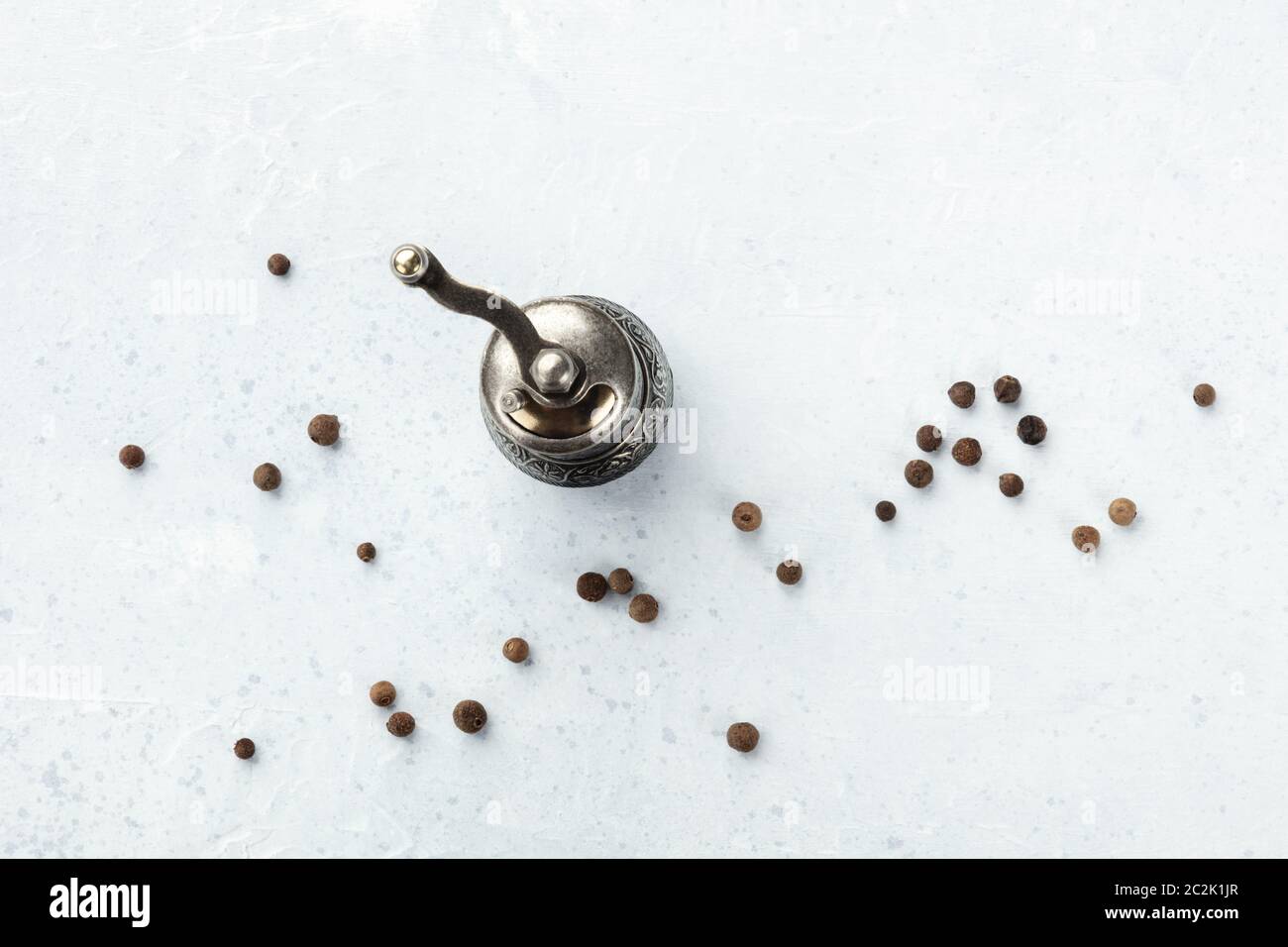 Allspice, Jamaica pepper. Black peppercorns with a vintage pepper mill ...