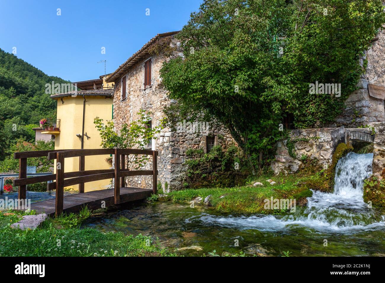 Typical Italian medieval town with a river flowing through it Stock ...