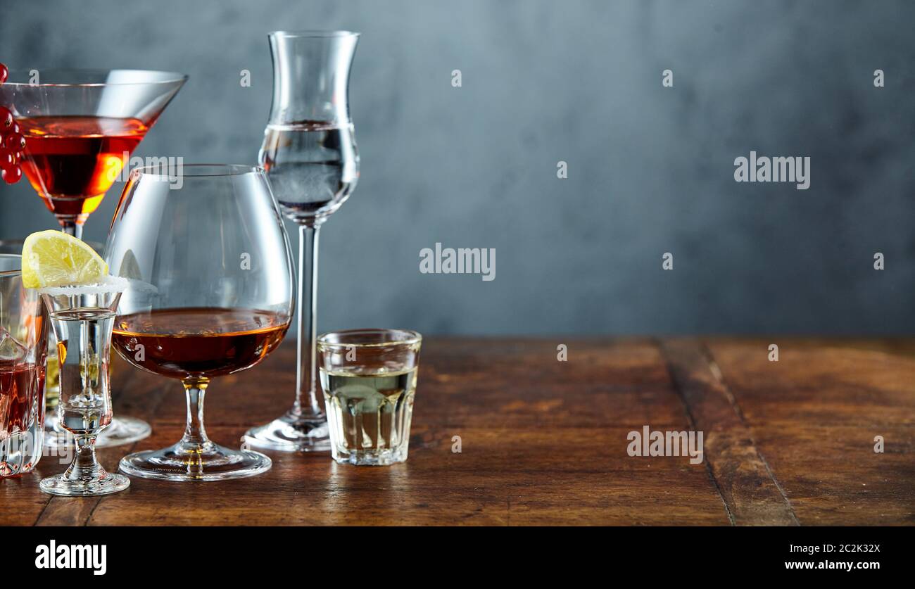 Assorted alcoholic beverages on rustic bar counter with copy space over ...