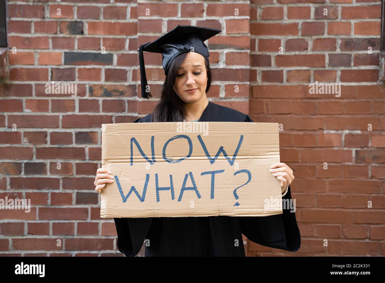 Sad college graduate holding diploma hi-res stock photography and ...