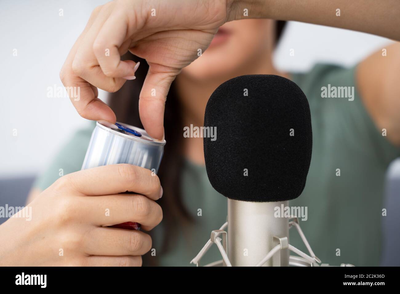 Woman Opening Can On Microphone To Make ASMR Sounds Stock Photo - Alamy