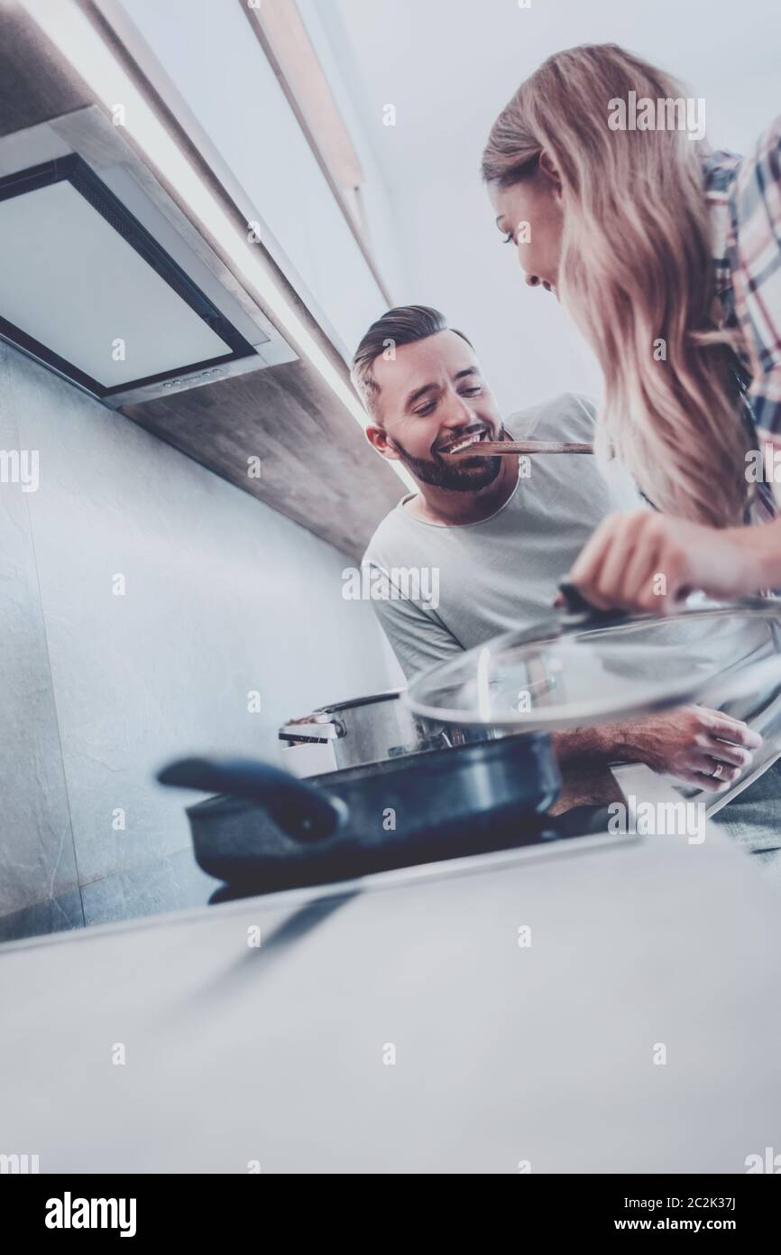 young husband and wife cook dinner together Stock Photo - Alamy