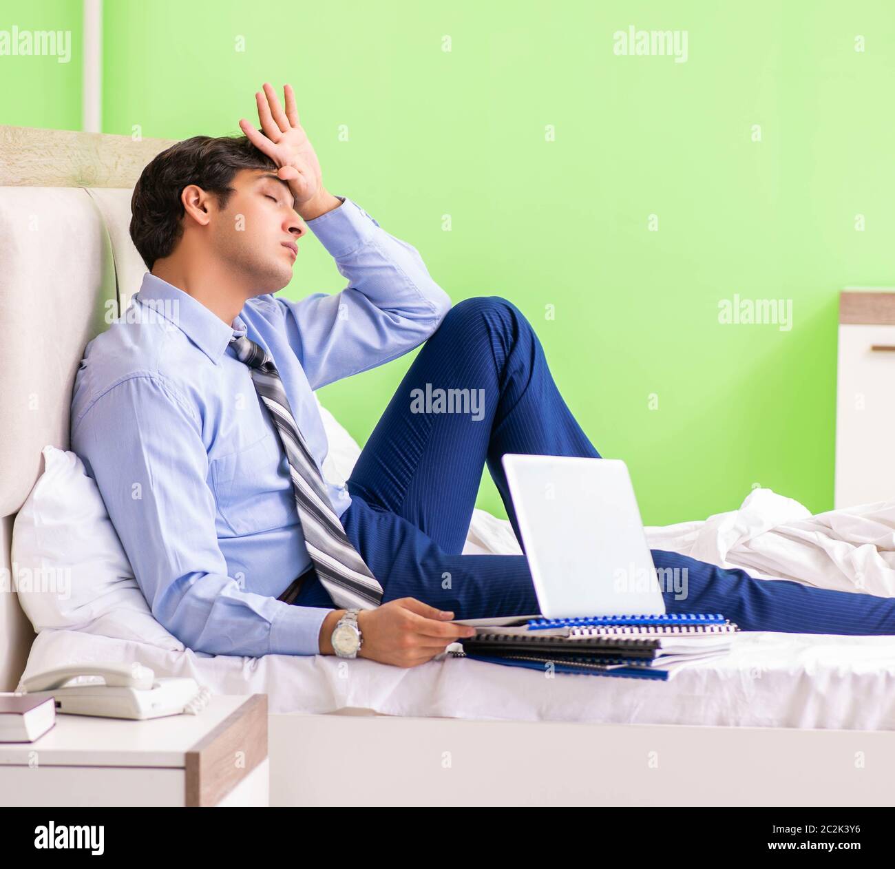 The businessman working overtime in hotel room Stock Photo - Alamy