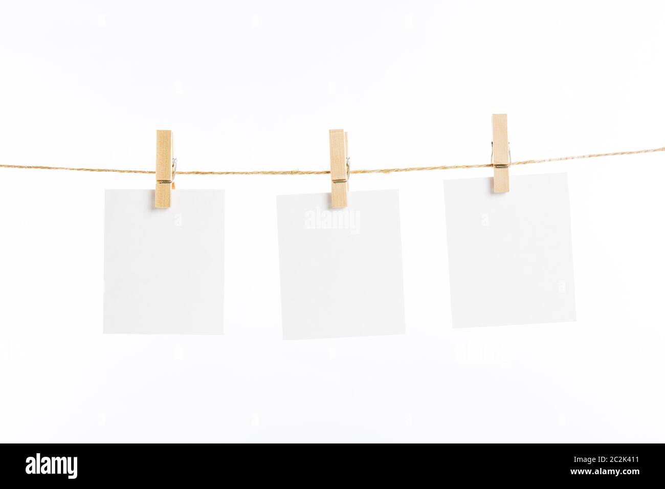 paper cards hanging rope isolated on white background Stock Photo - Alamy