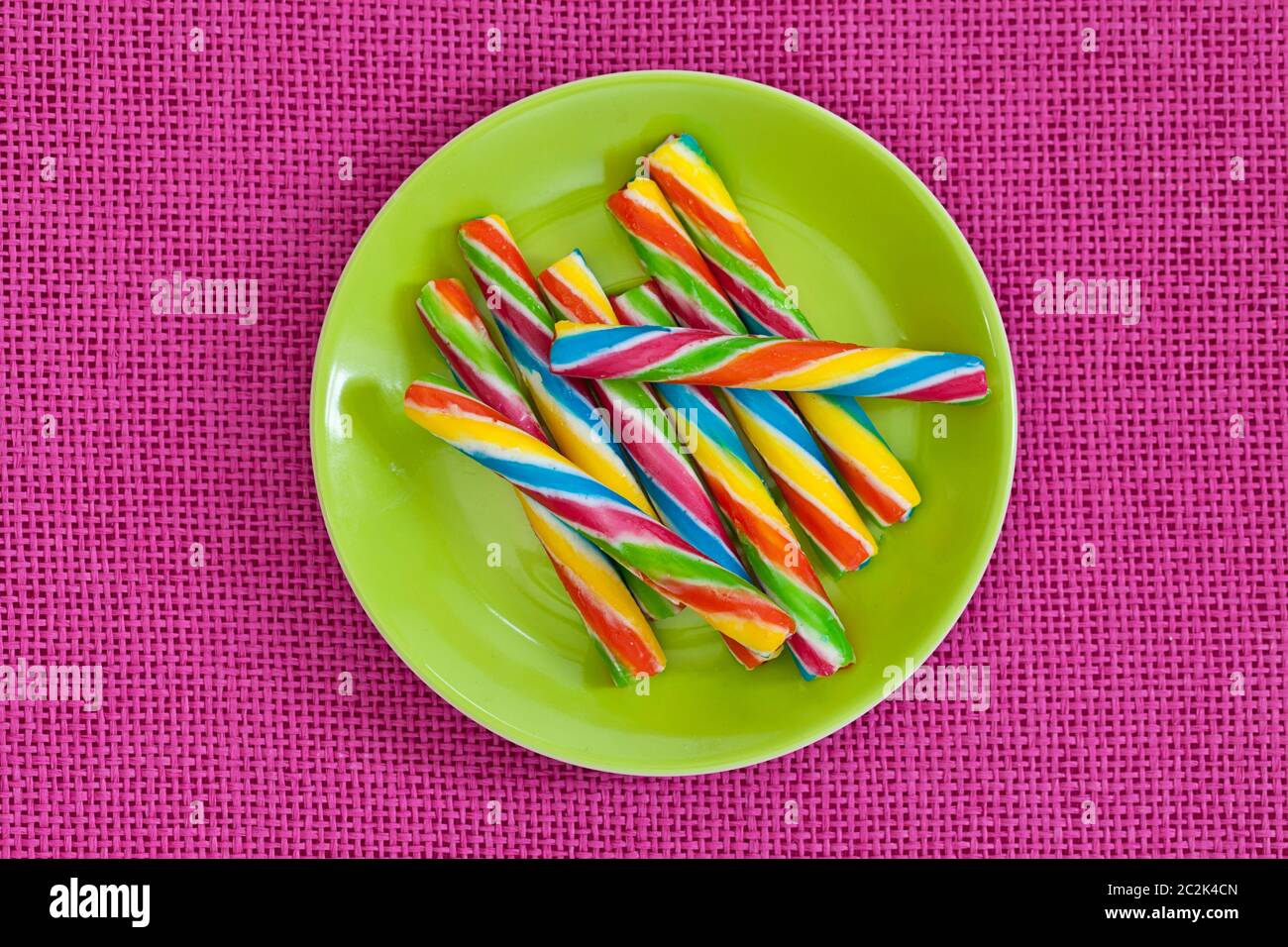colorful sweet treats, candy canes on a green plate Stock Photo - Alamy