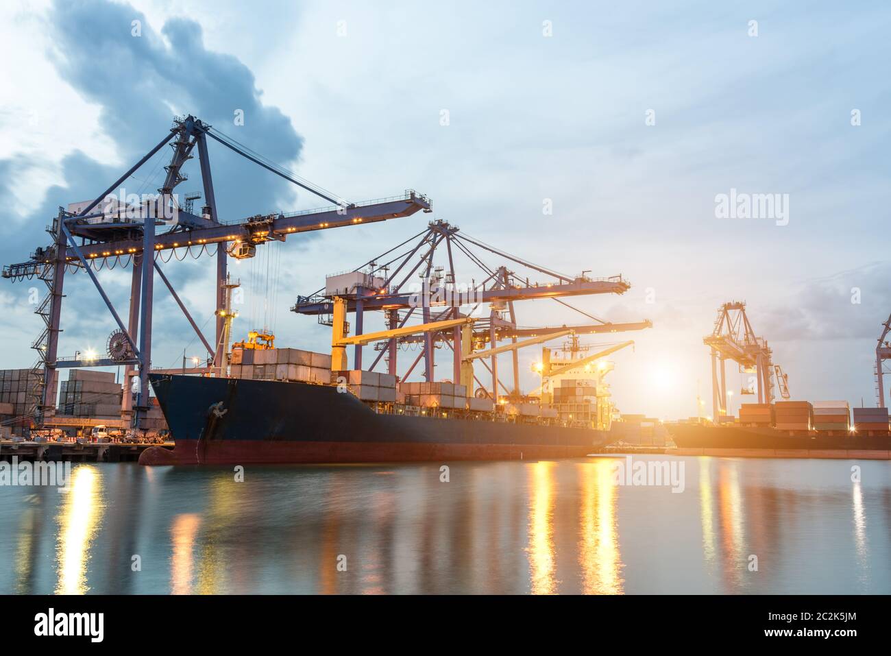 Container ship in the harbor at sunrise Stock Photo - Alamy
