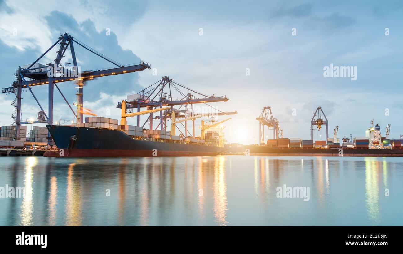 Container ship in the harbor at sunrise Stock Photo - Alamy